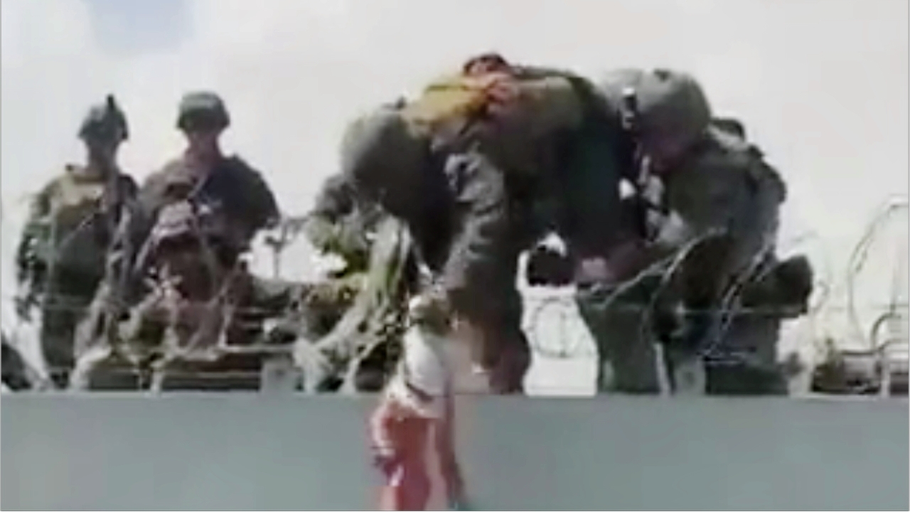 Afghan Baby Lifted by US Marine Over Wall of Kabul Airport Reunited ...